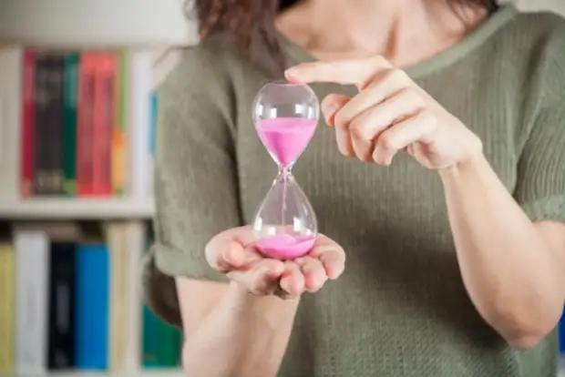 Hourglass in the hands of a woman