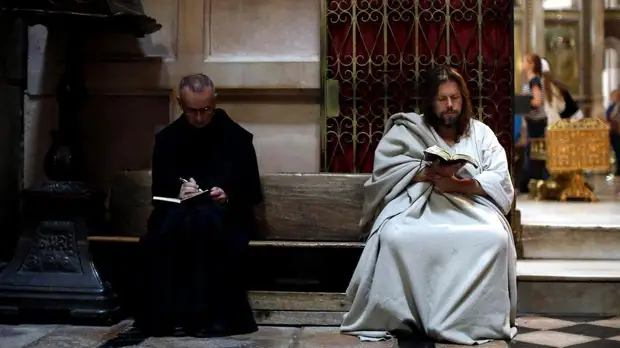 Pilgrim reads the Bible in the Jerusalem Temple of the Holy Sepulcher